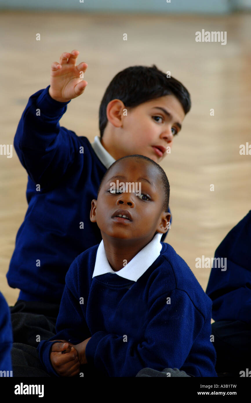 Mixed group of primary school children join in a group discussion with ...