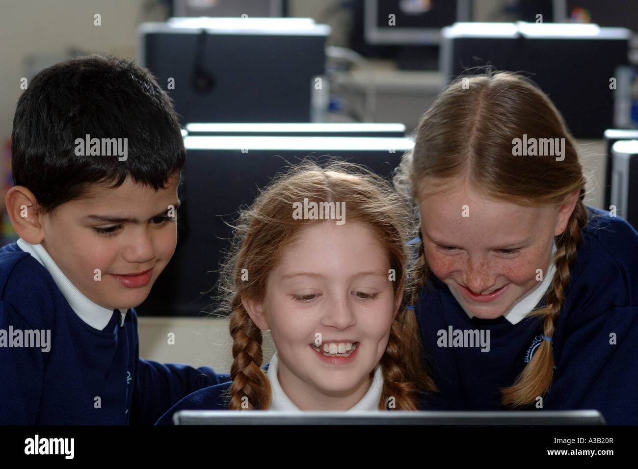 Primary school children use a computer in the IT Suite Stock Photo - Alamy