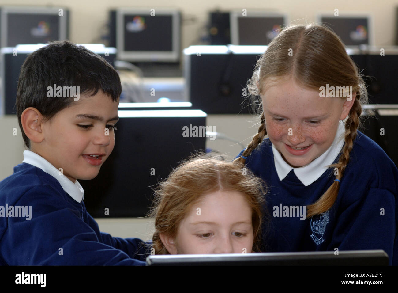 Primary school children use a computer in the IT Suite Stock Photo - Alamy