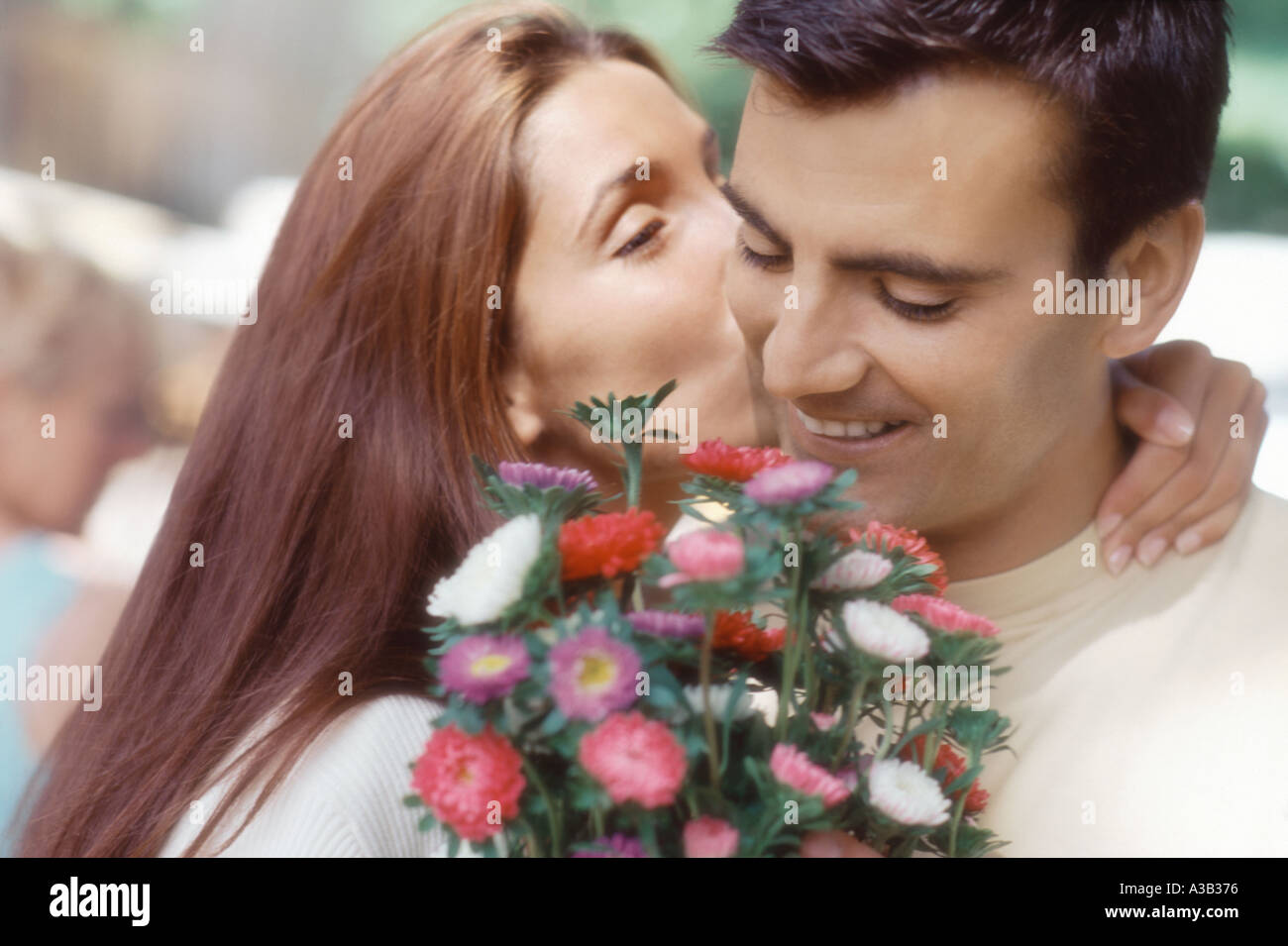 Romantic couple with bouquet of flowers Stock Photo - Alamy