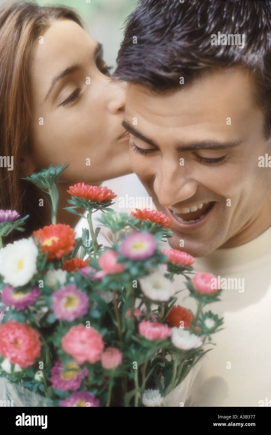 Romantic couple with bouquet of flowers Stock Photo - Alamy