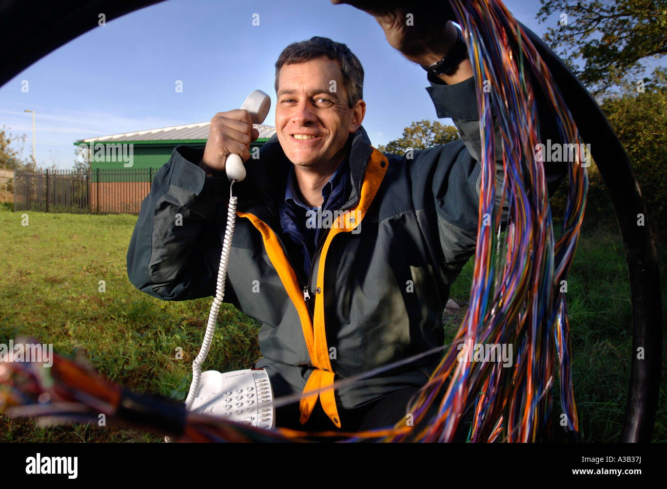 A TELECOMMUNICATIONS NETWORK DESIGNER WITH TELEPHONE CABLES AT AN ...