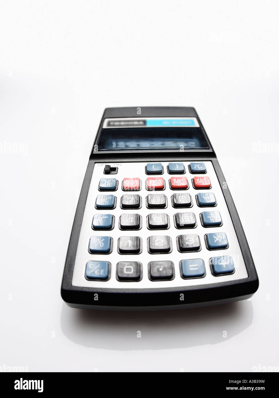 Old fashioned pocket calculator on white background - reflections on ...