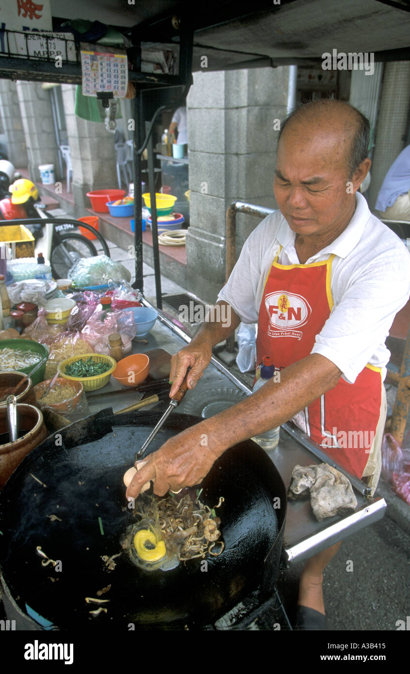 Man cooking food on a roadside food stall, Penang, Malaysia Stock Photo ...