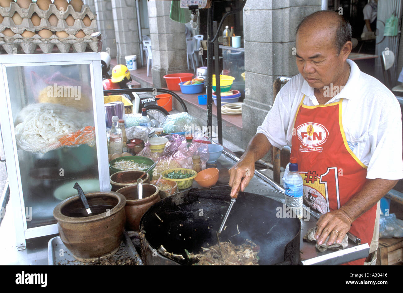 Man cooking food on a roadside food stall, Penang, Malaysia Stock Photo ...