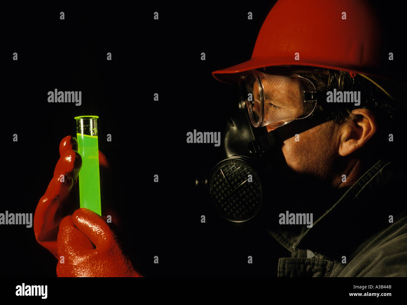 chemical worker wearing protective goggles mask gloves helmet examining ...