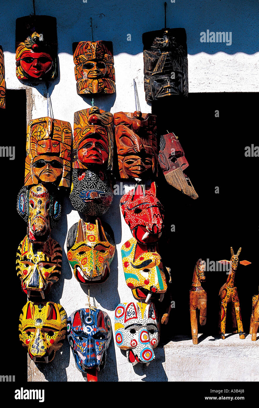 Different kinds of the masks hanging on the wall Stock Photo - Alamy