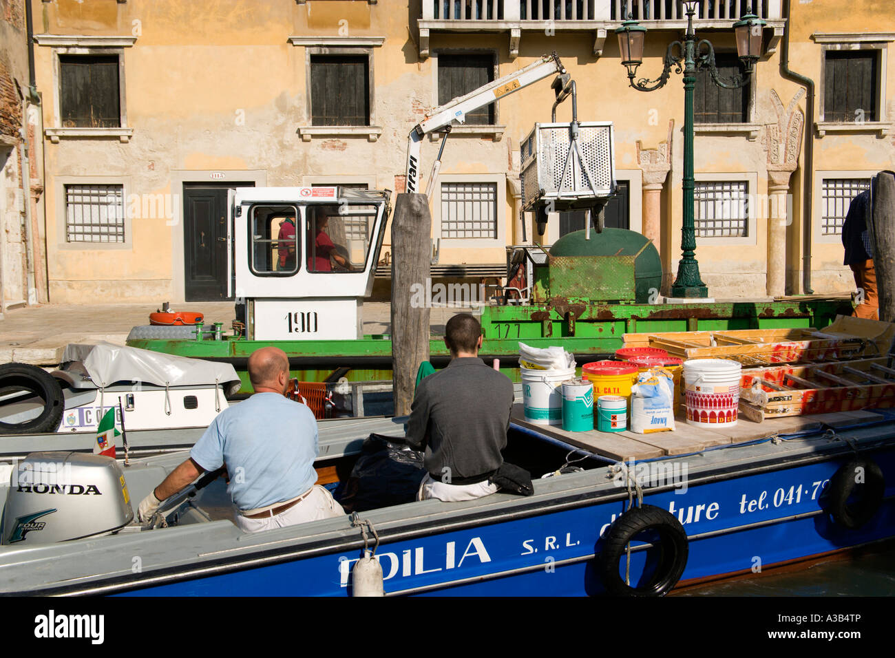 ITALY Veneto Venice Grand Canal Refuse collection boat with crane hoist ...