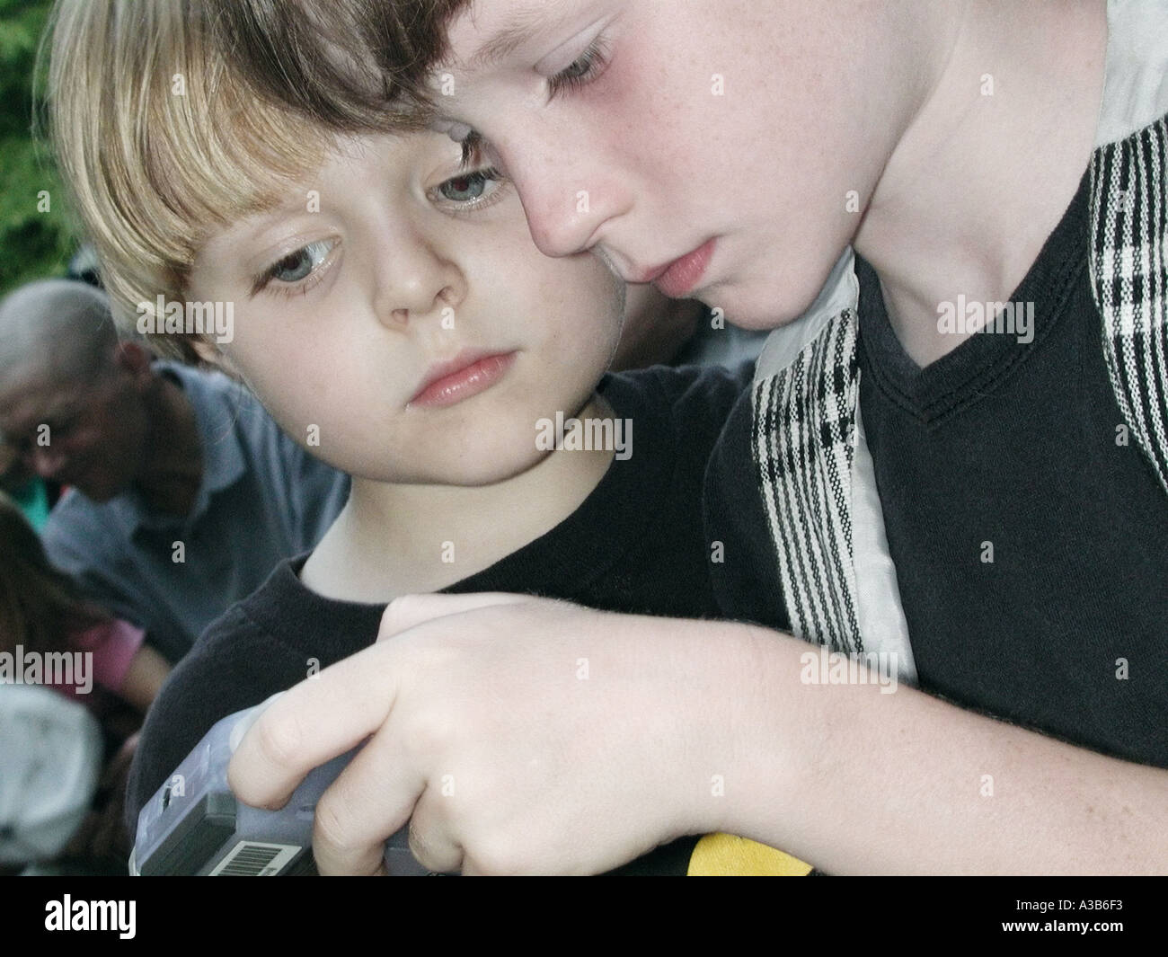Boys playing hand held video game Stock Photo - Alamy
