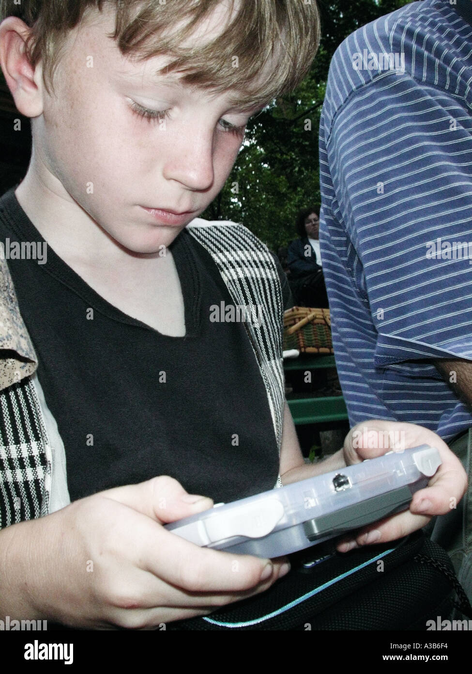 Nine year old caucasian boy playing hand held video game Stock Photo ...