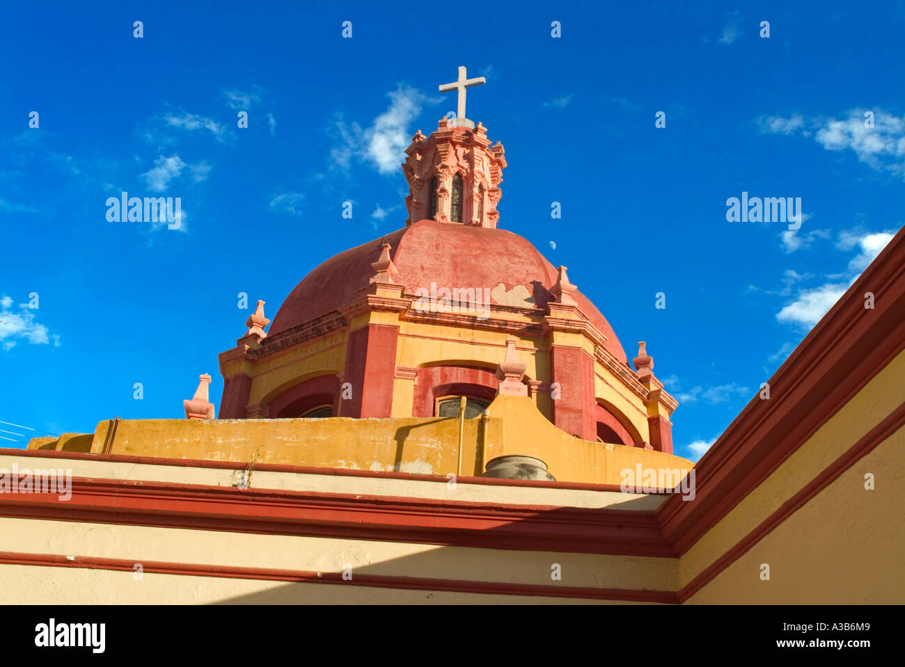 Close up of exterior church cupola with a religious cross on top in ...