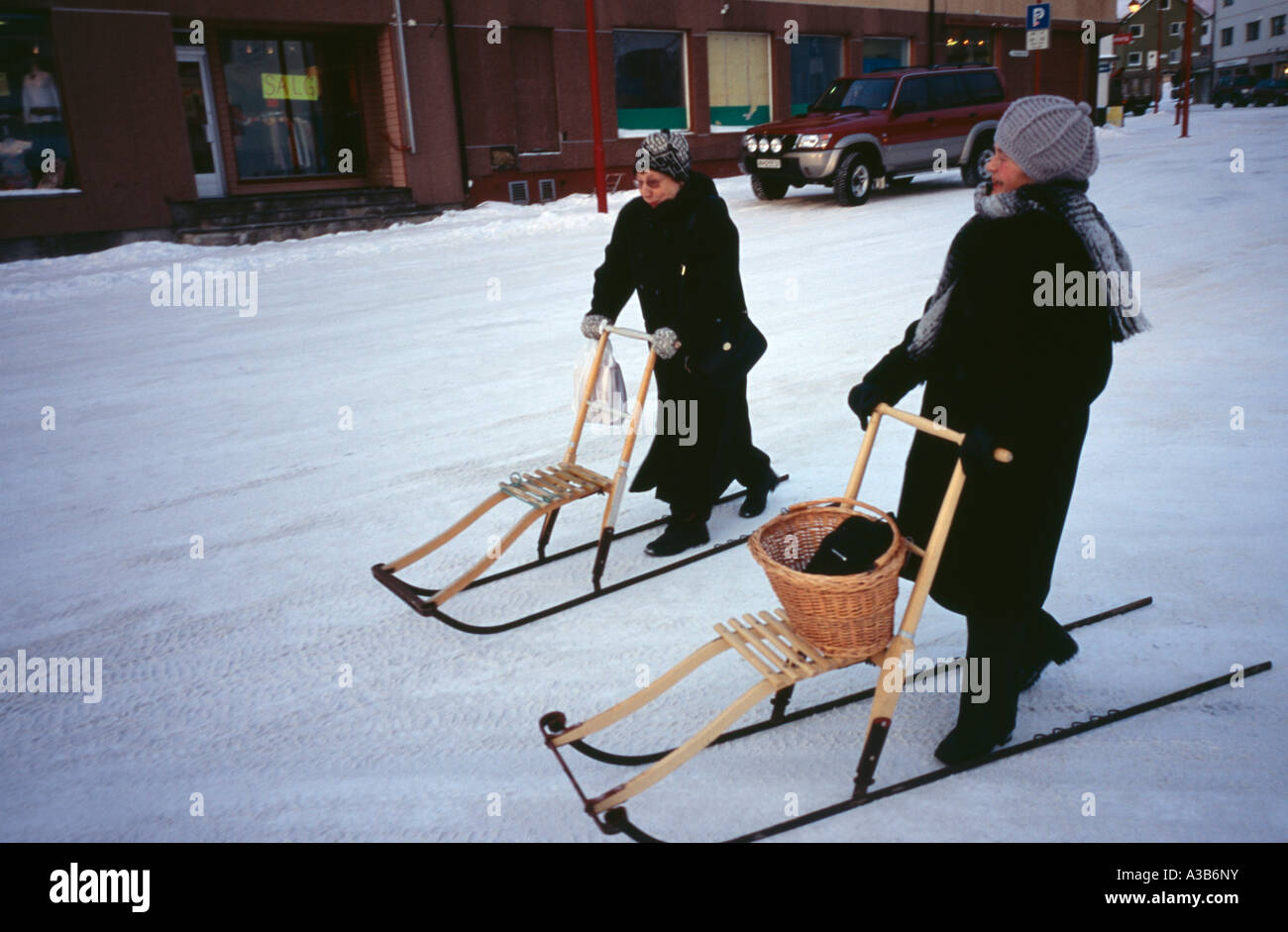 NORWAY Scandinavia Honningsvag People Female shoppers in snow using ...