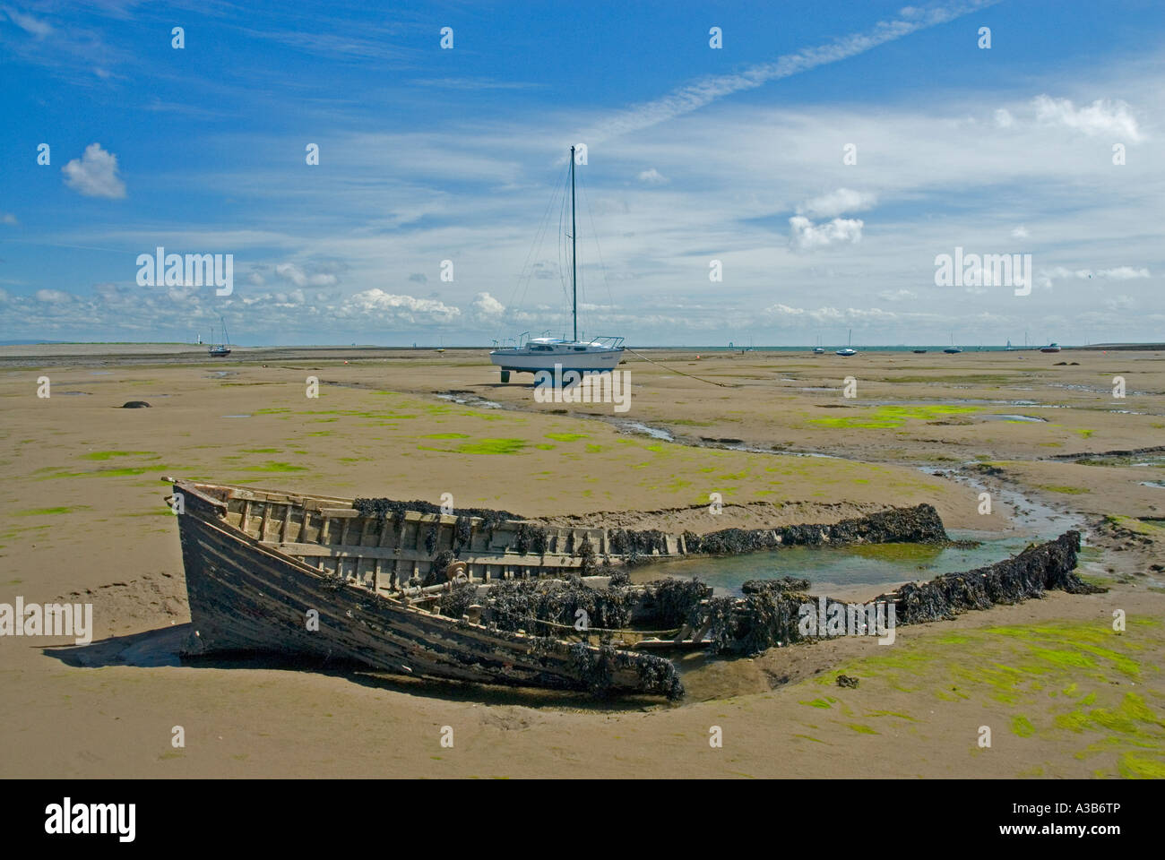 Derelict wooden boat on sandy beach. Rampside, Morecambe Bay, Cumbria ...