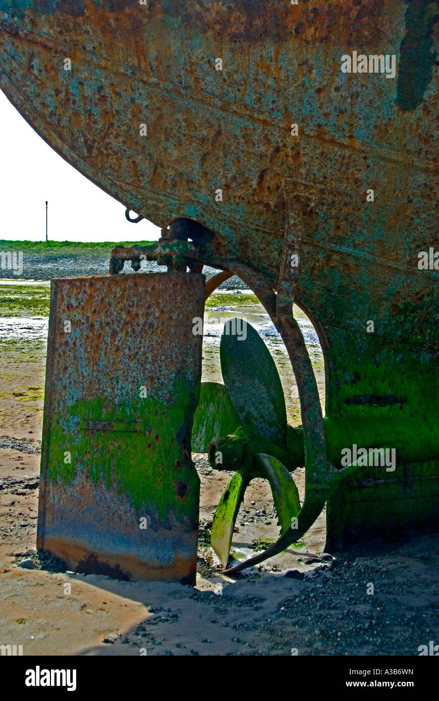 Detail of rudder and propeller of beached, derelict fishing trawler ...