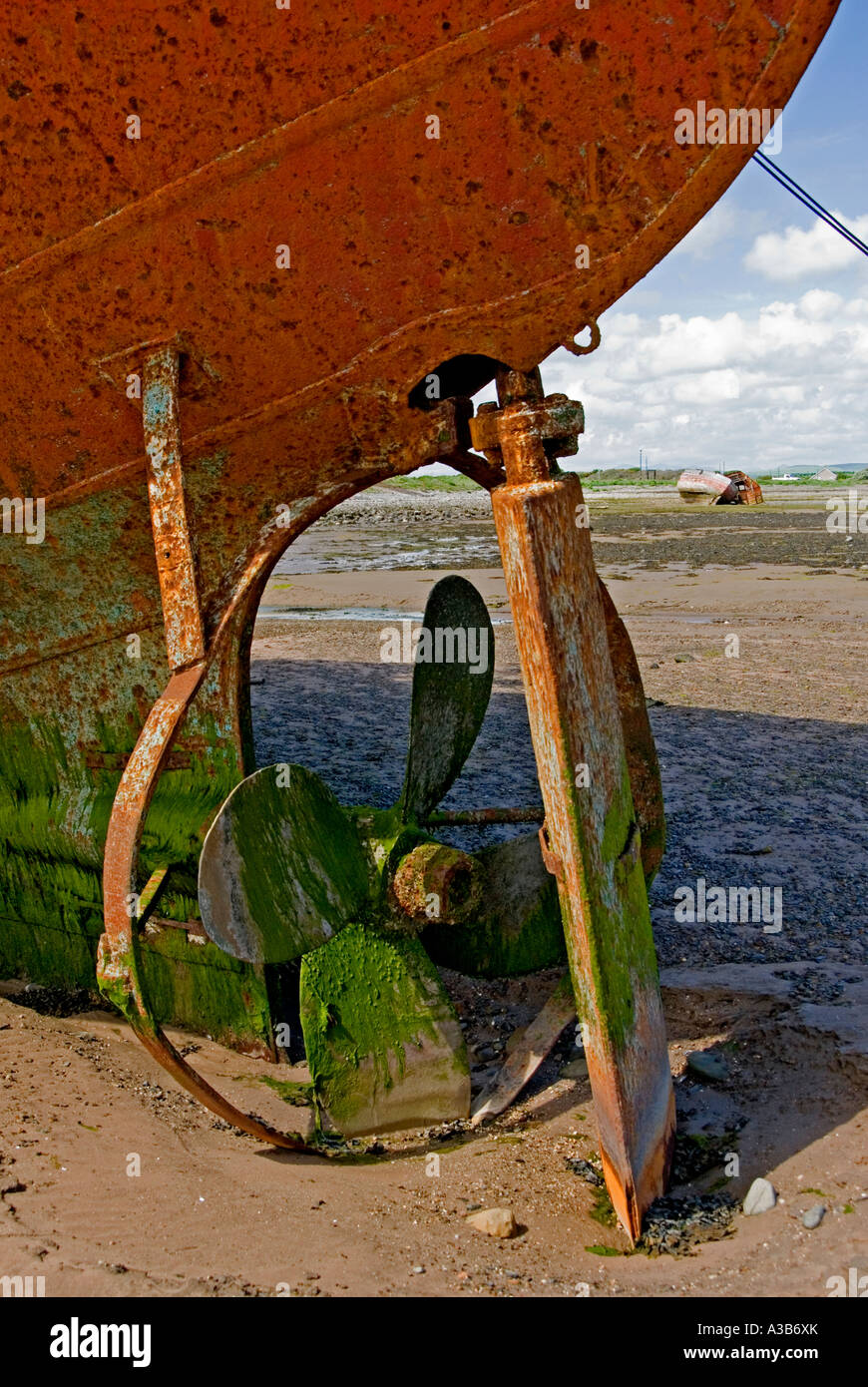 Detail of rudder and propeller of beached, derelict fishing trawler ...