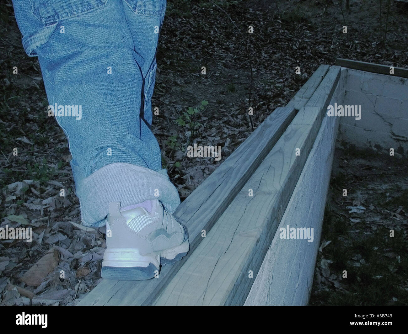 Child walking on ledge at dusk Stock Photo - Alamy