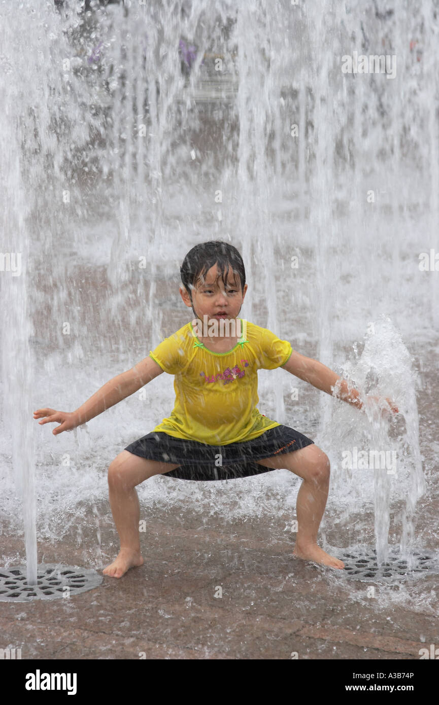 Girl Playing In Fountain Stock Photo - Alamy