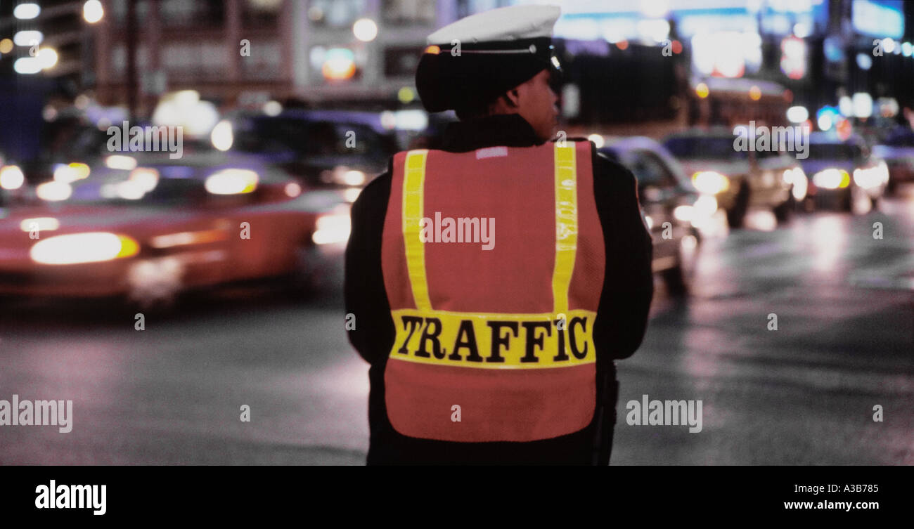 Traffic officer and traffic at night Mid town Manhattan New York City ...