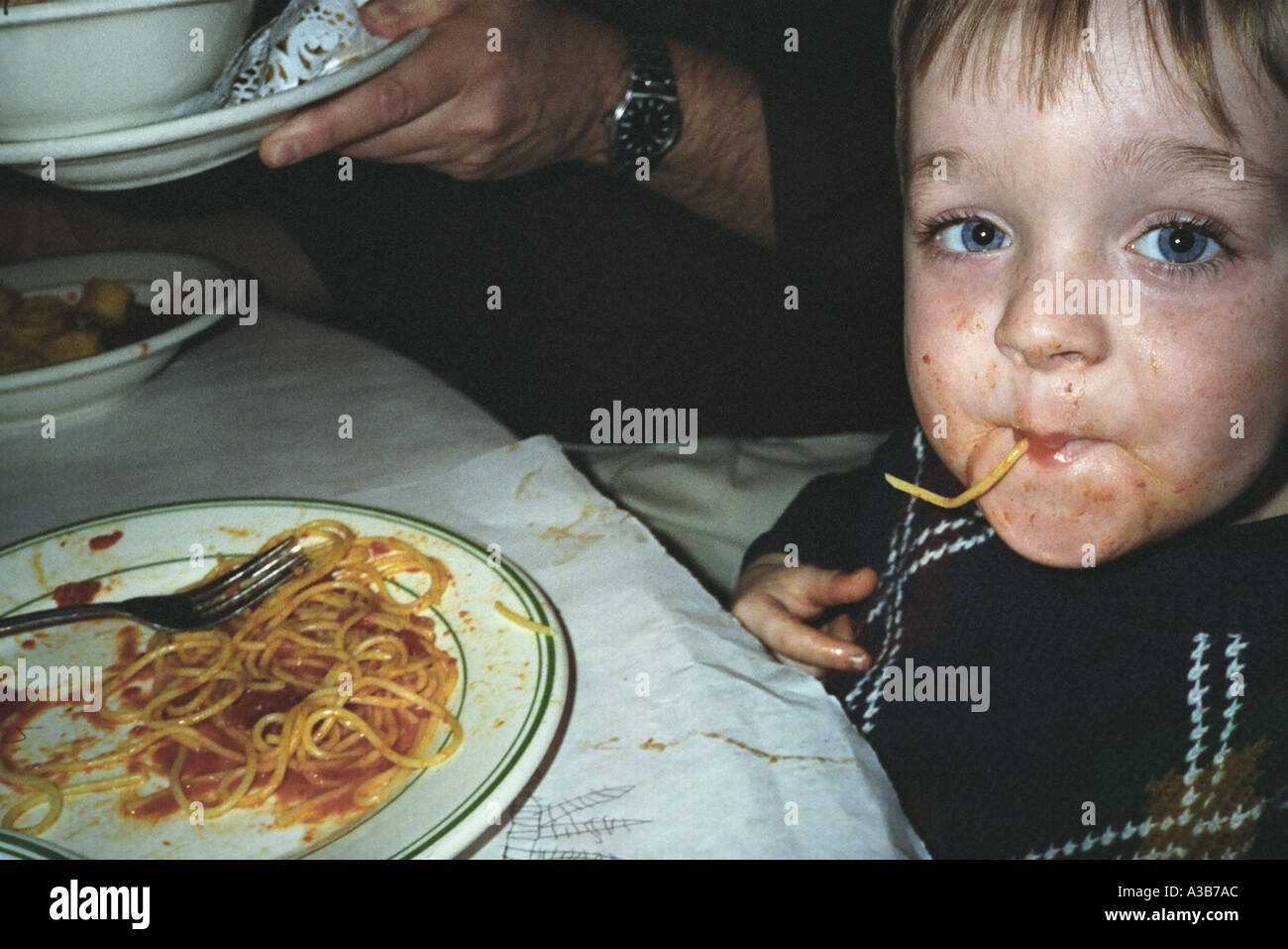 Five year old boy slurping spaghetti in a restaurant Stock Photo - Alamy