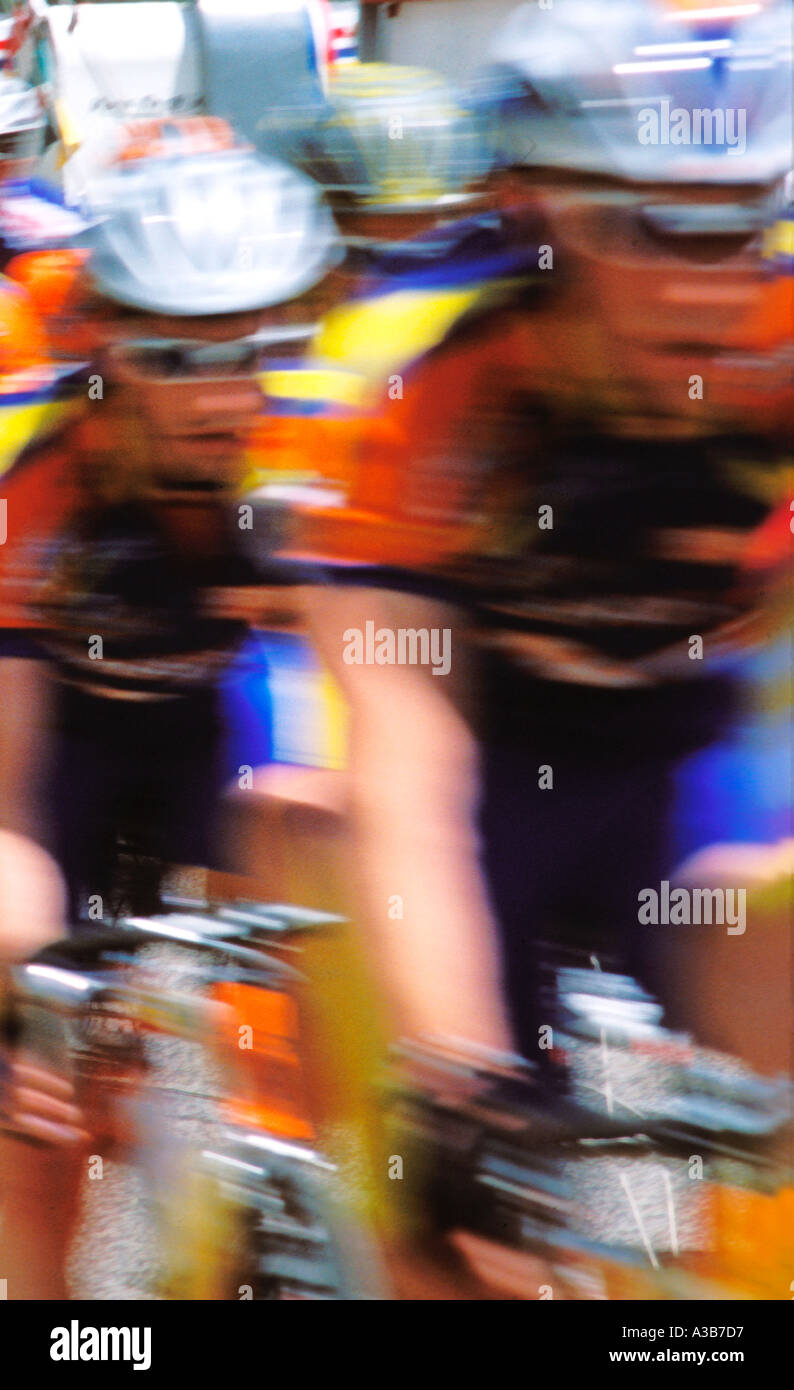 Bike racers are packed tightly as they move through the frame on a ...