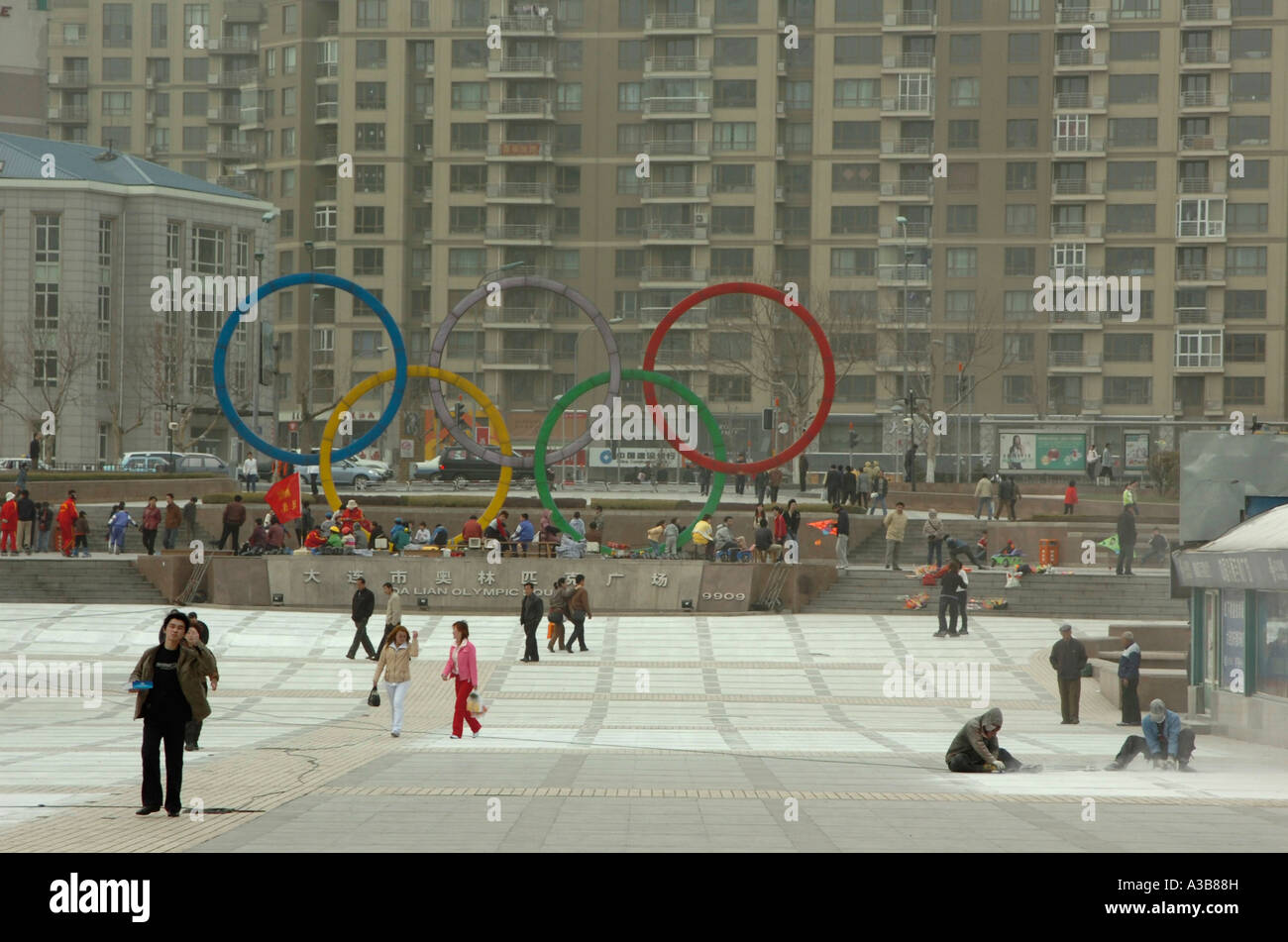 CHINA Asia Liaoning Dalian people in square under repair with Olympic ...