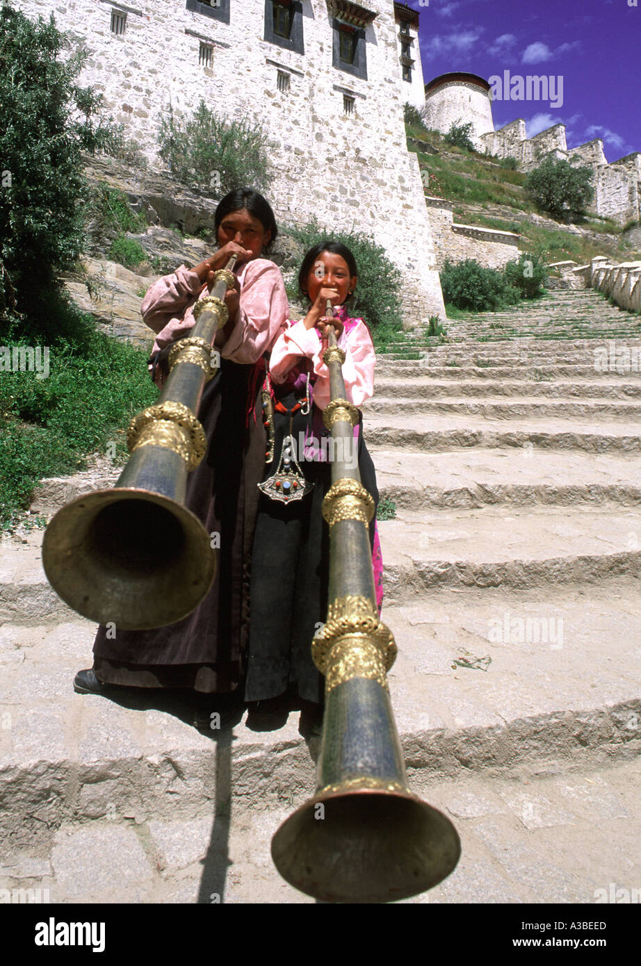 Tibetan girls playing horns in front of the Potala Palace Lhasa Tibet ...