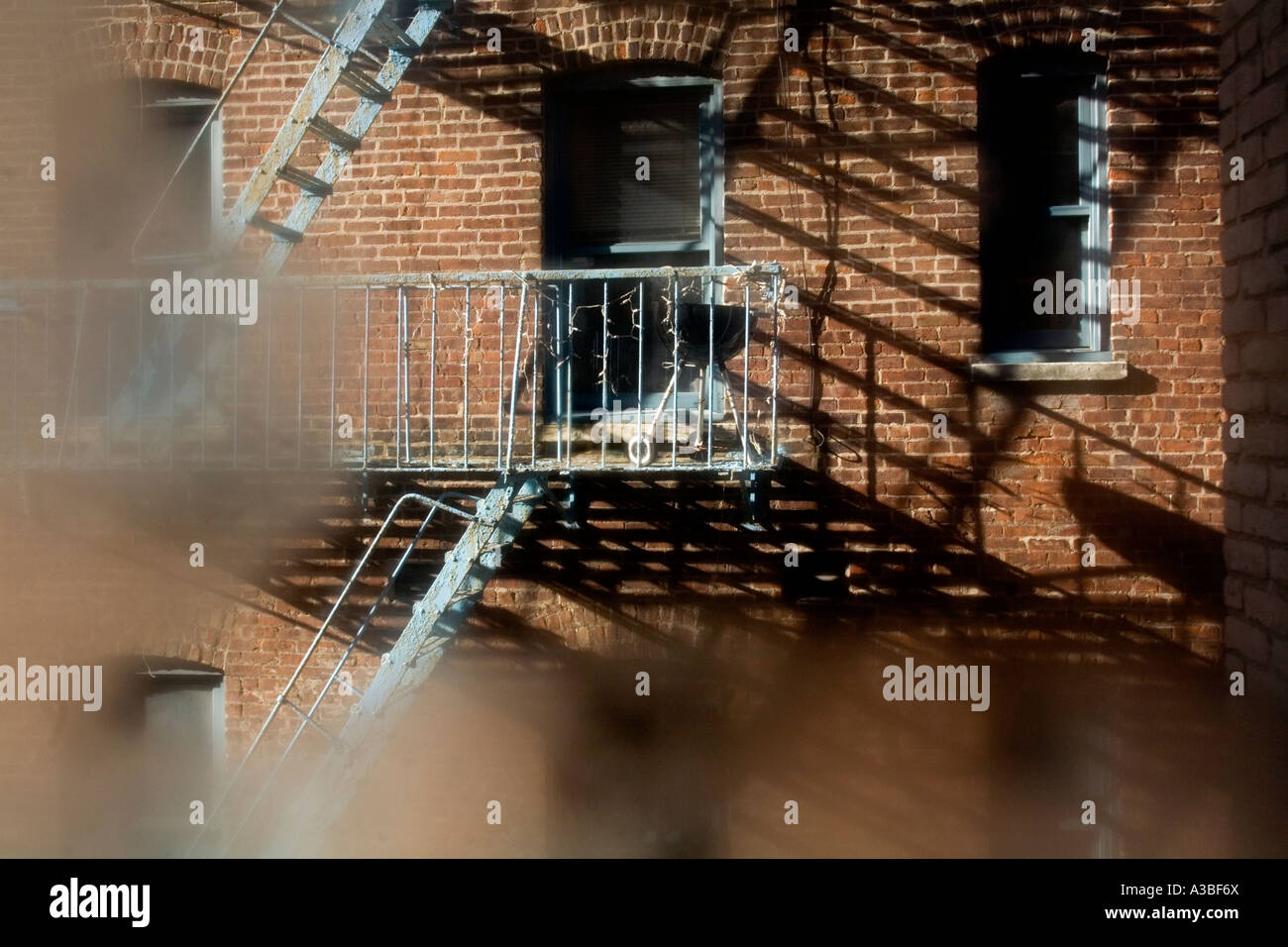 Fire escape and windows seen on side of apartment building Stock Photo ...