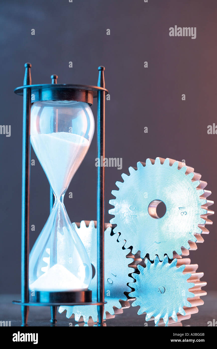 an hourglass and three saw-teethed wheels Stock Photo - Alamy