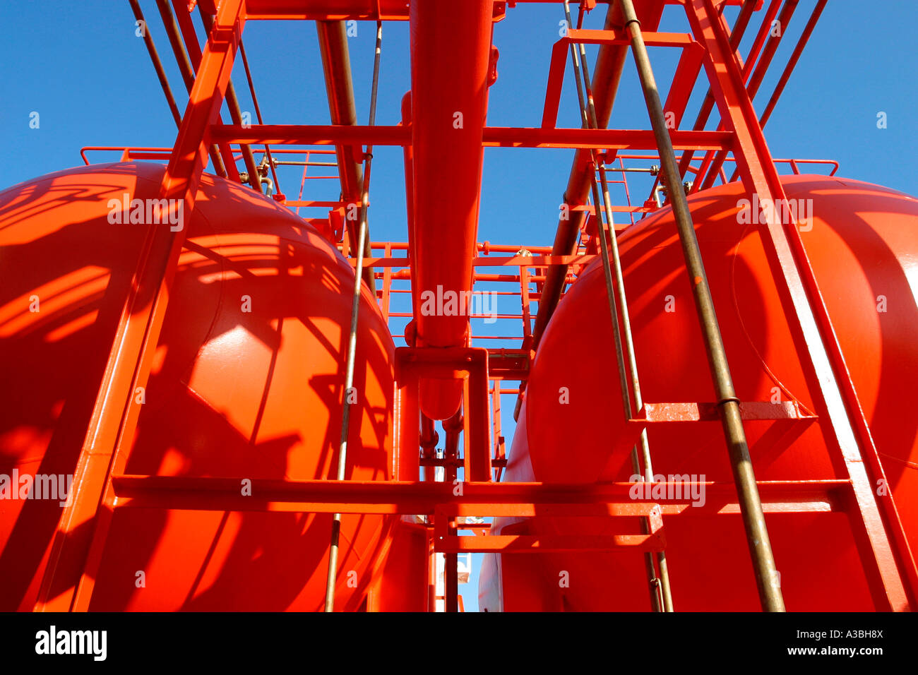 Bright red gas tank and pipes Stock Photo - Alamy
