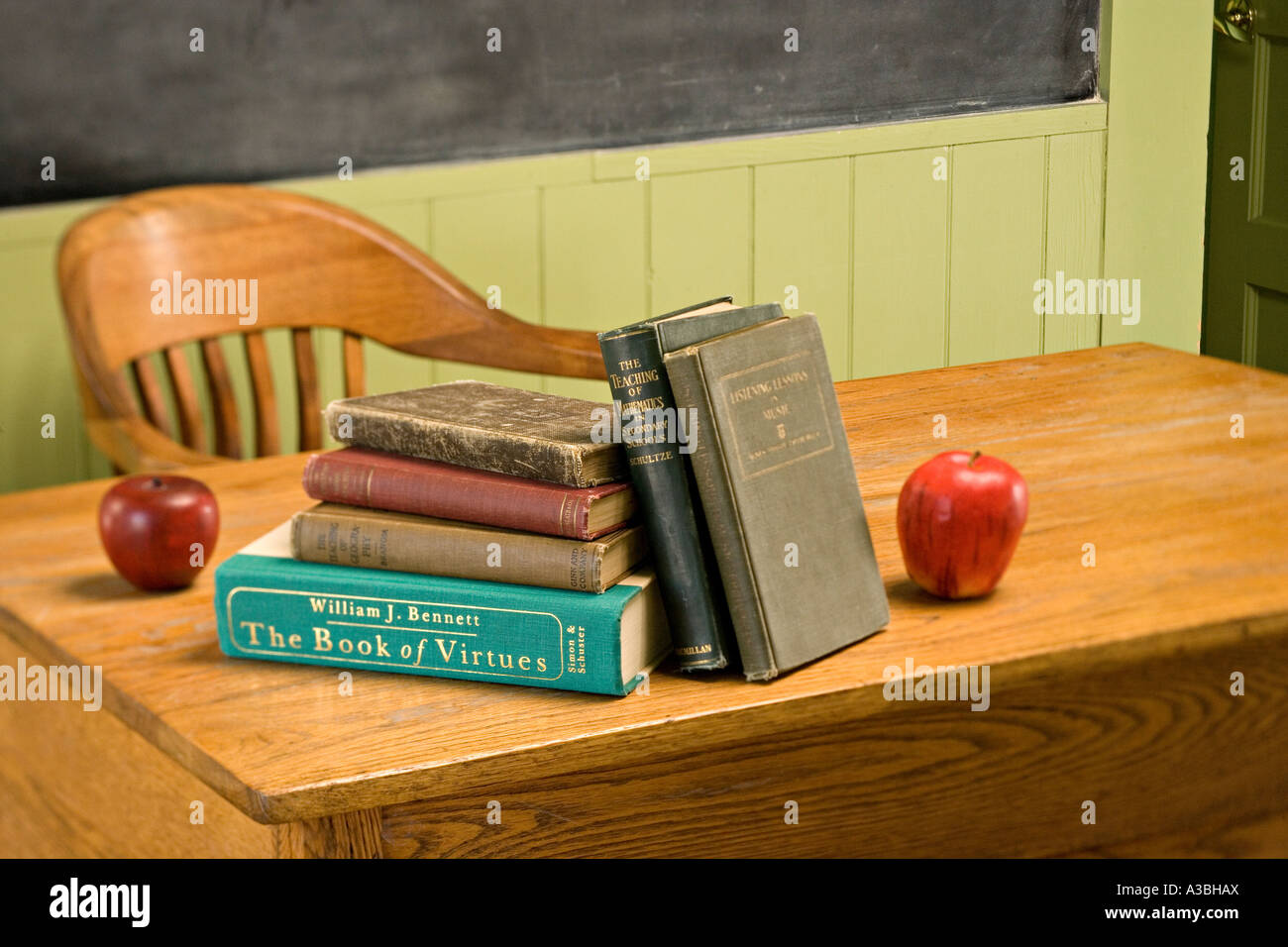 Back to school books on desk with apple and chalkboard Stock Photo - Alamy