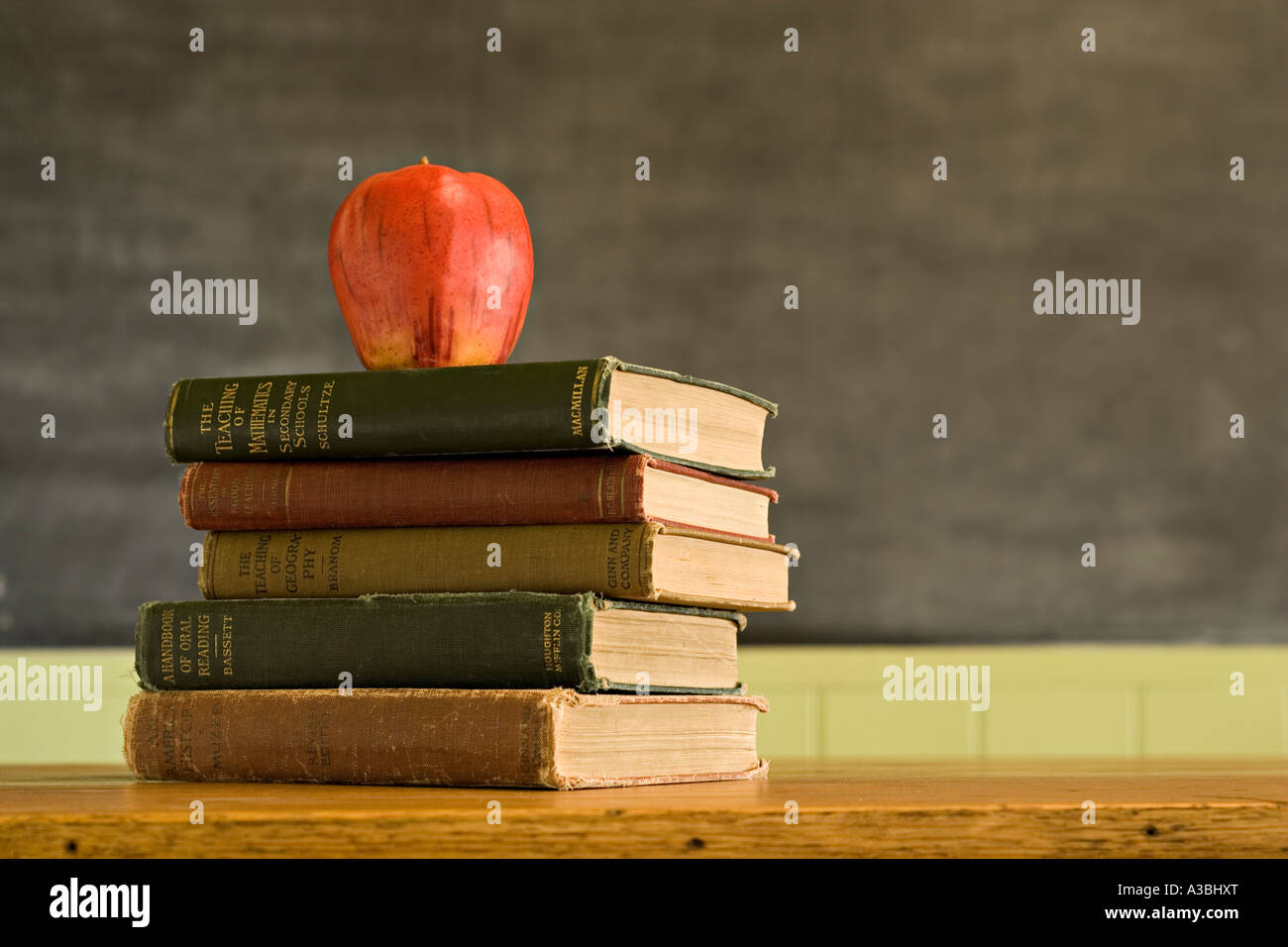 Back to school books on desk with apple and chalkboard Stock Photo - Alamy