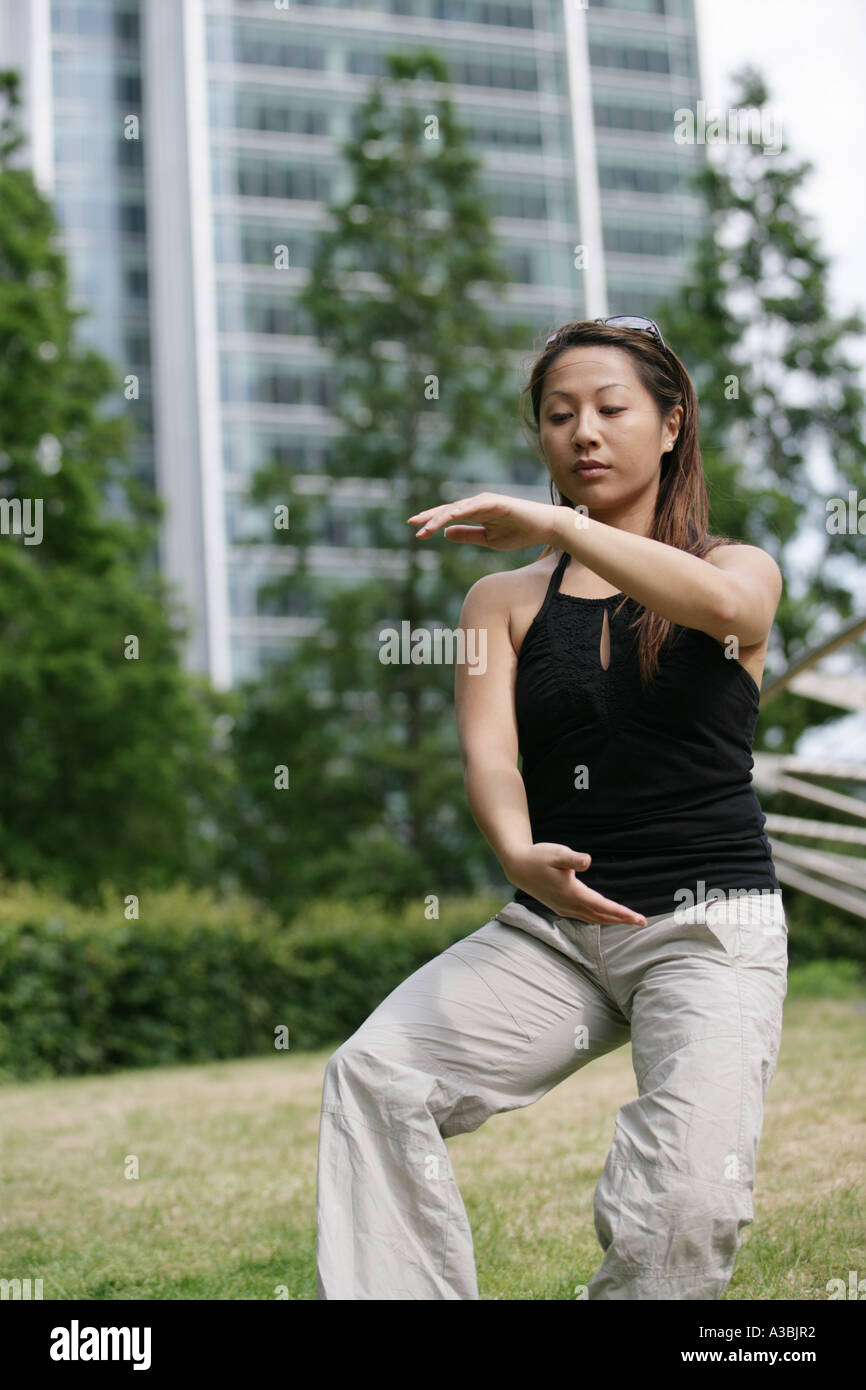 Woman doing Tai Chi in the city/park Stock Photo - Alamy