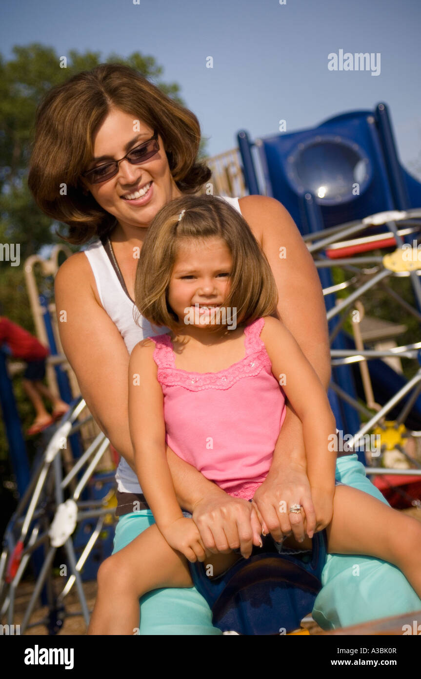 Woman and girl on teeter totter Stock Photo - Alamy