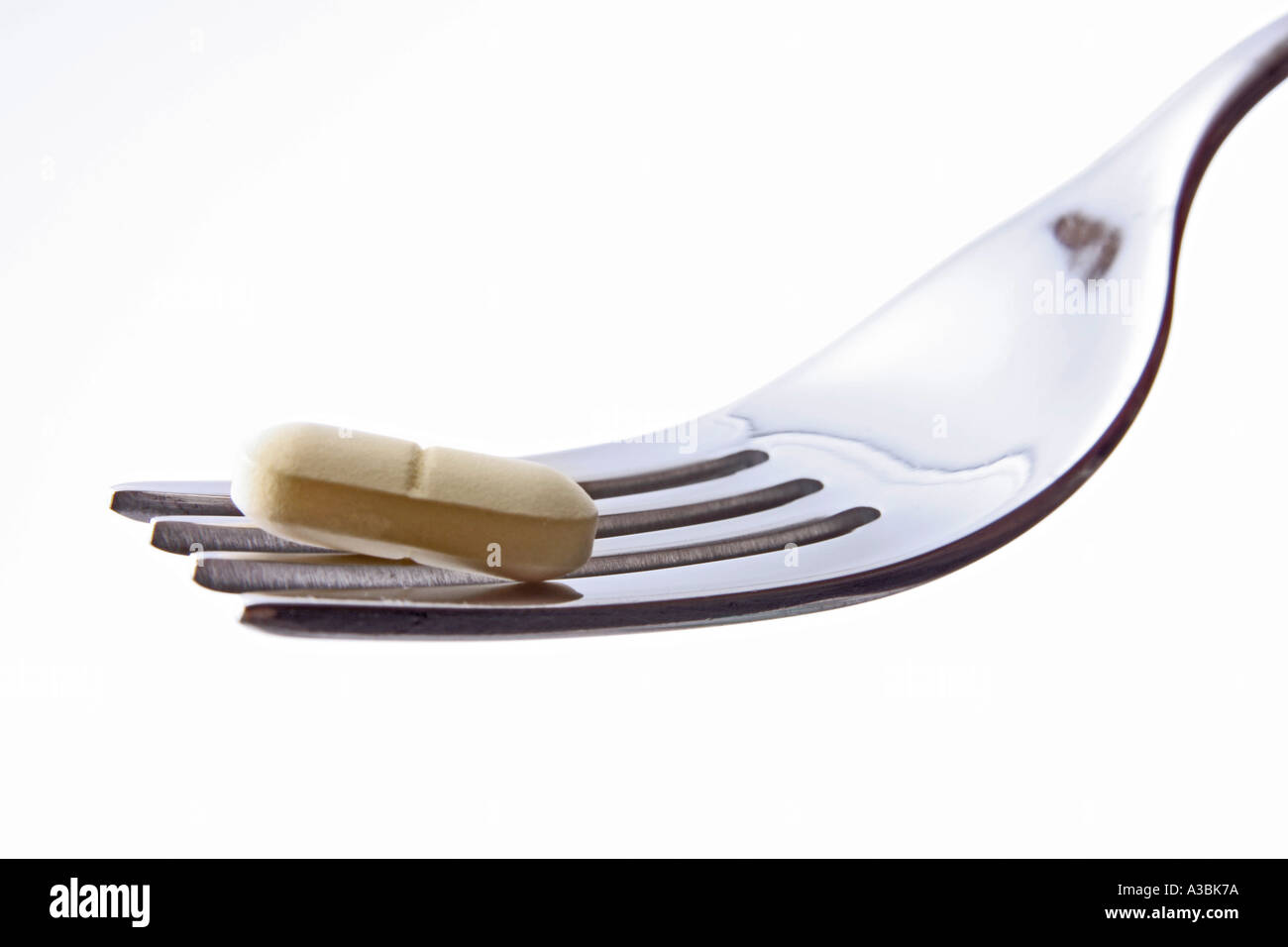 Capsule on fork Stock Photo - Alamy
