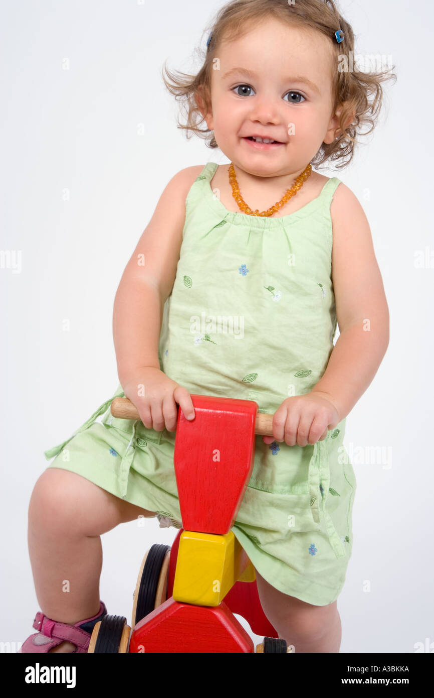 Toddler (18-24 months) riding wooden tricycle Stock Photo - Alamy