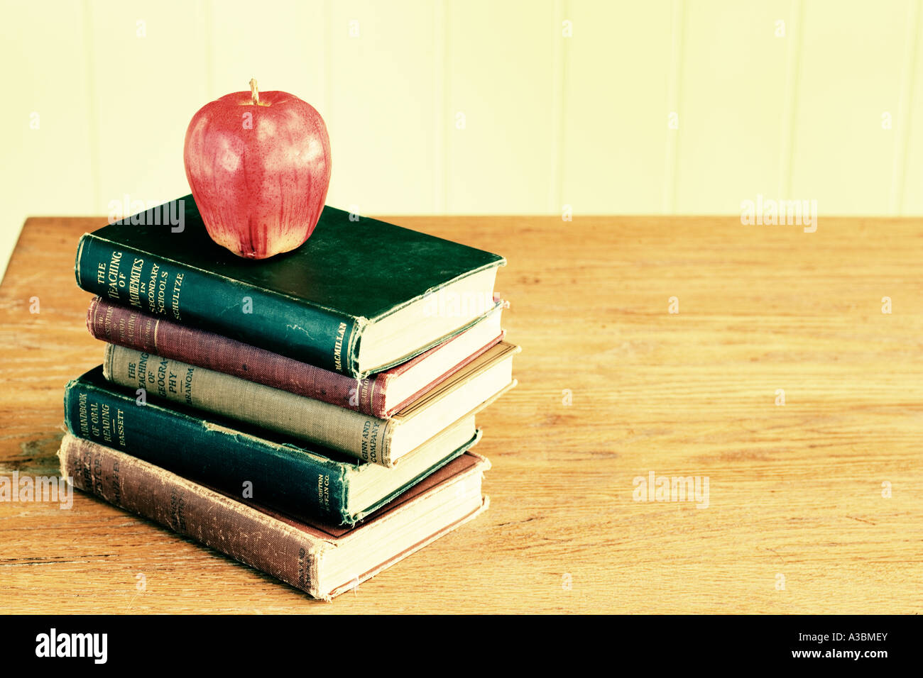 Back to school books on desk with apple Stock Photo - Alamy