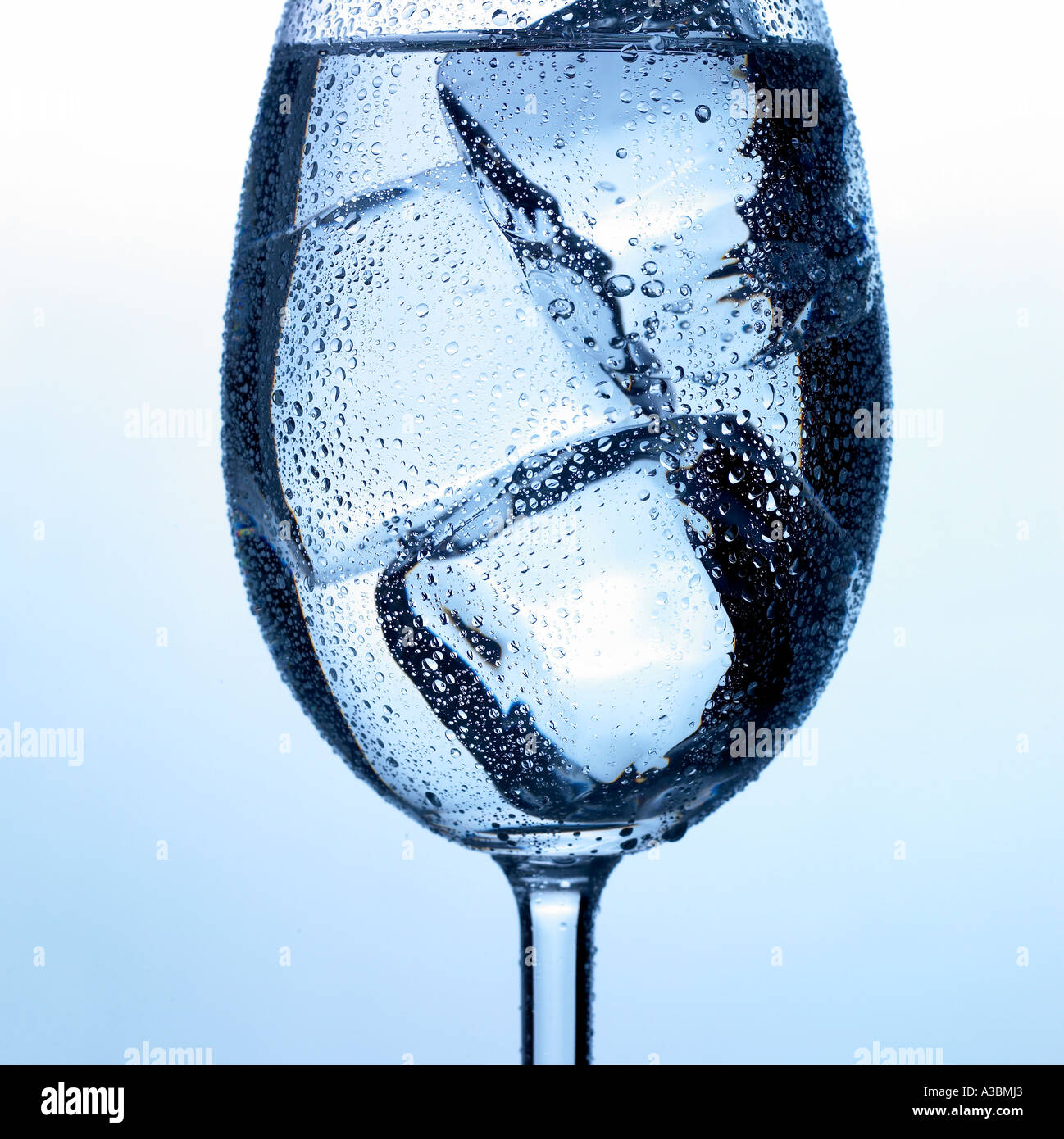 water and ice cubes in a wine glass Stock Photo - Alamy