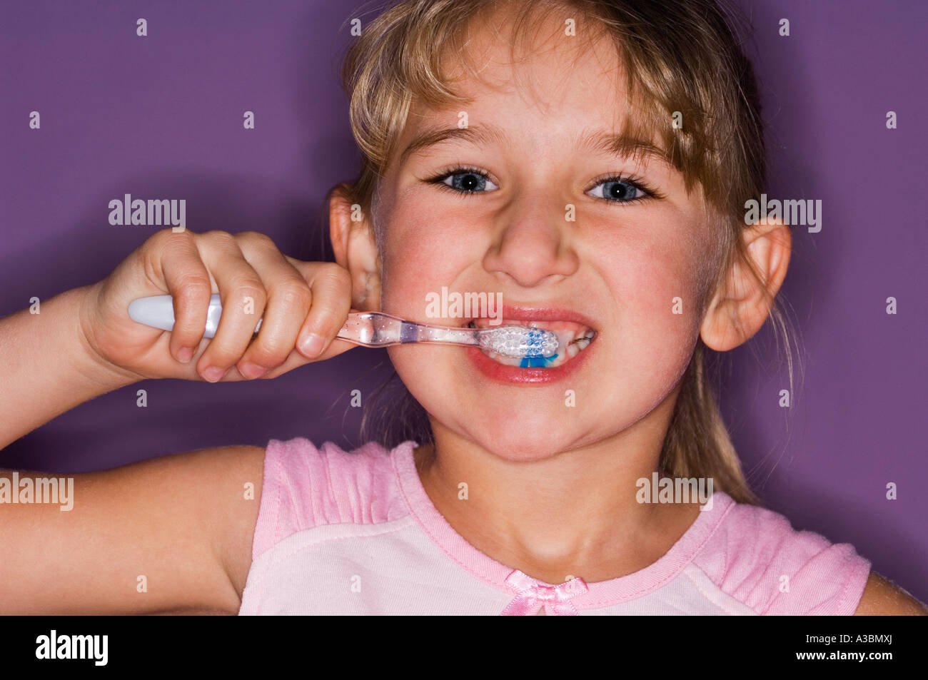 Girl brushing her teeth Stock Photo - Alamy