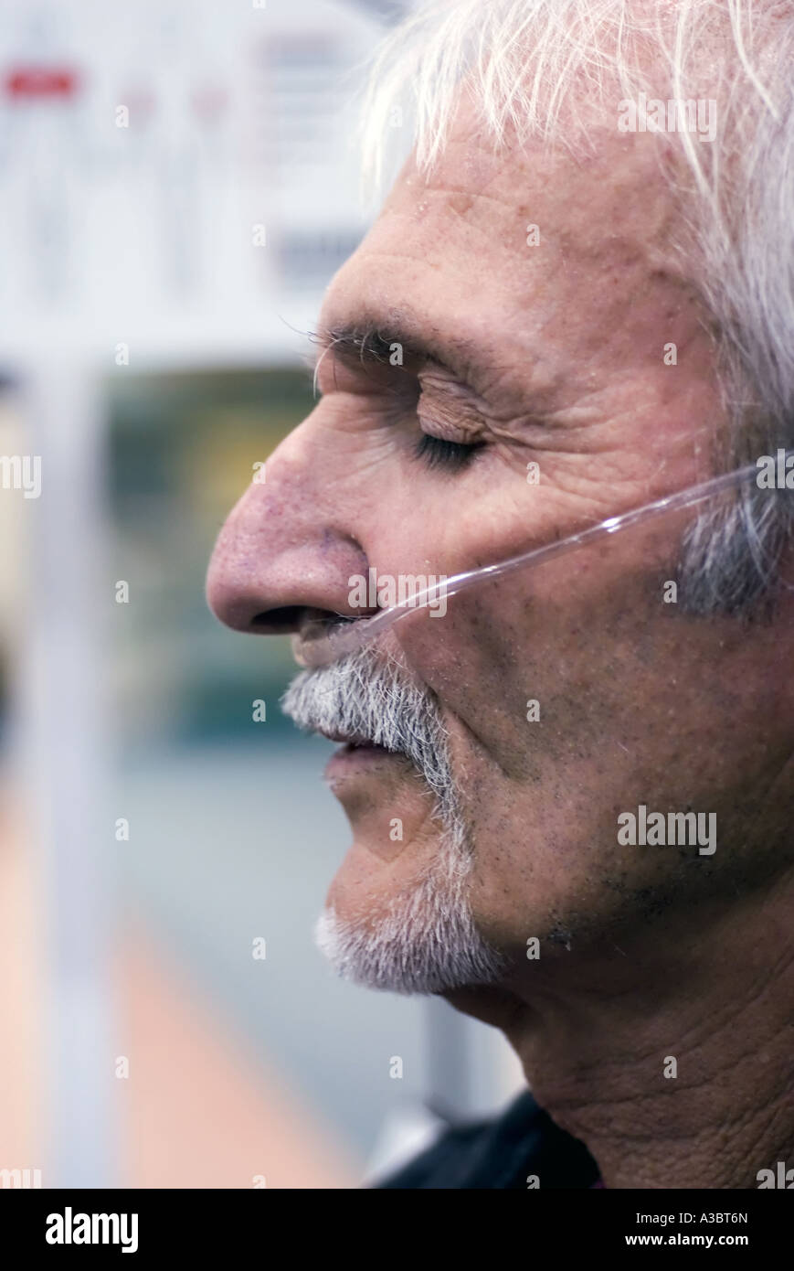Elderly Man suffering from lung disease wears an oxygen mask as he ...