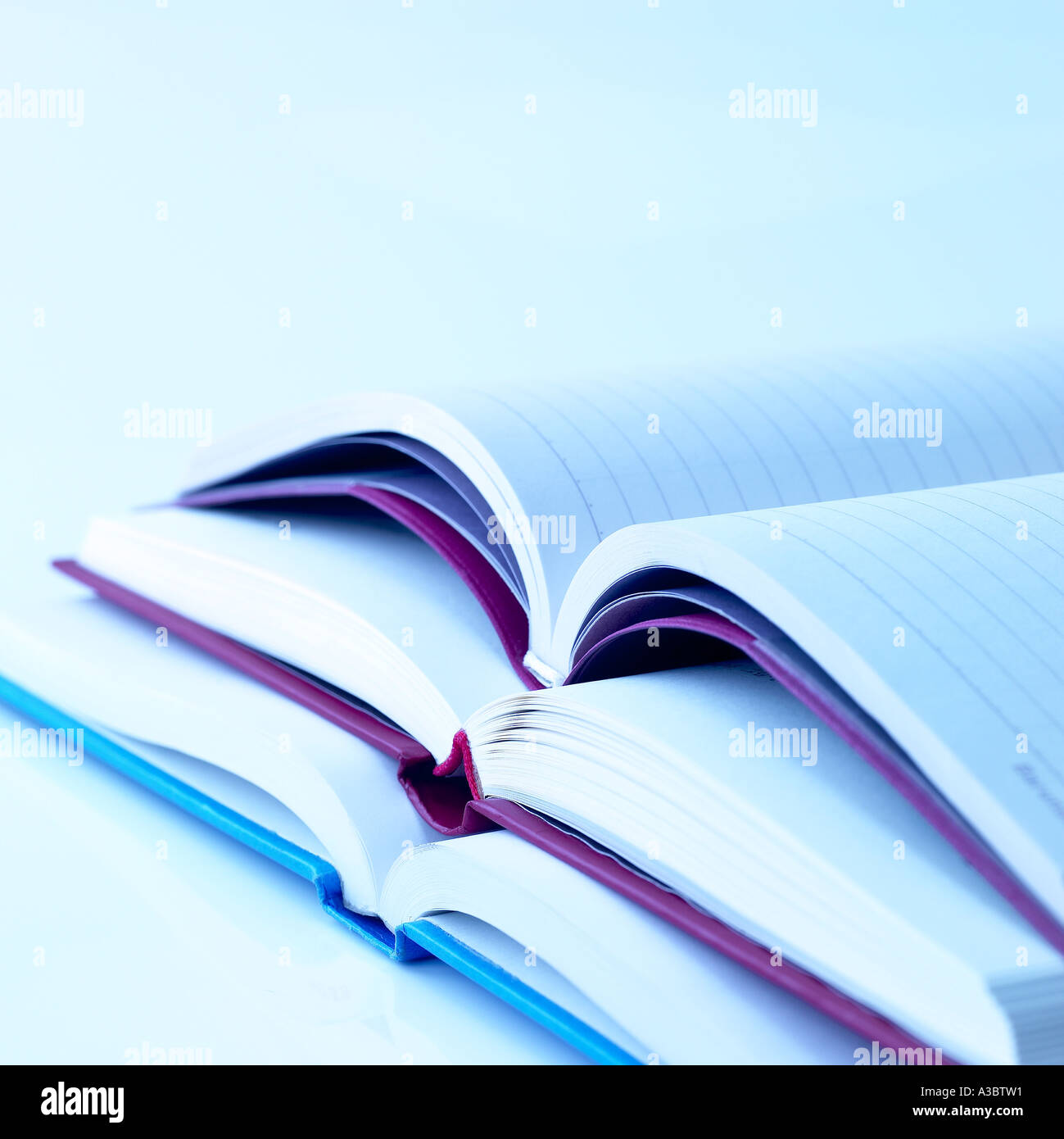 three open books are piled Stock Photo - Alamy