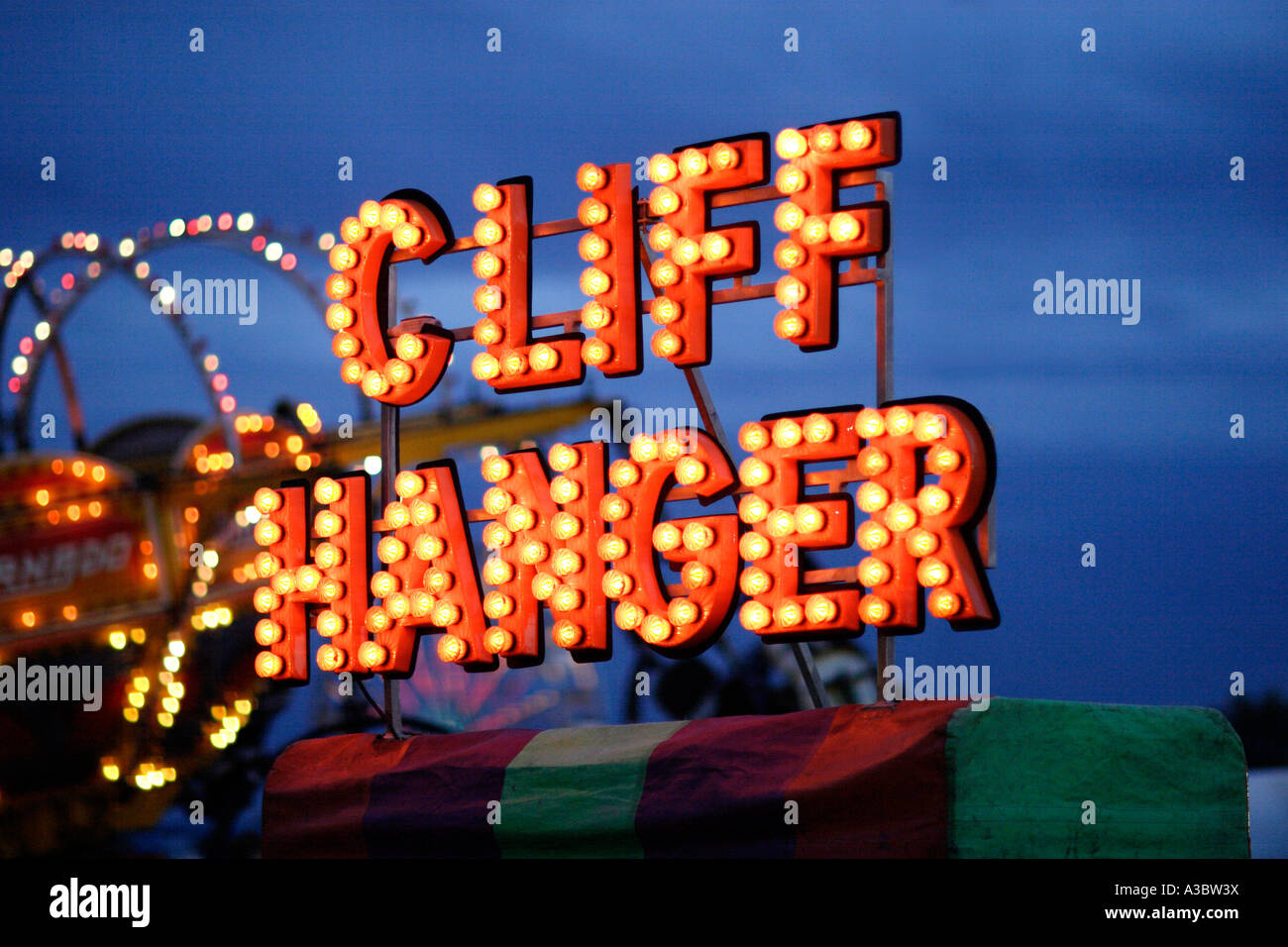 Carnival ride sign at night Stock Photo - Alamy
