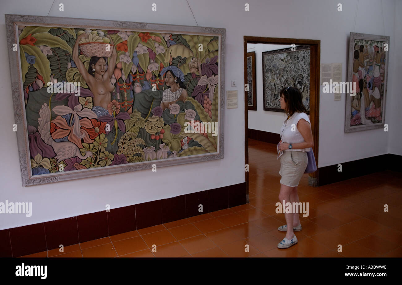 Neka Art museum, Ubud, Island of Bali. European holidaymaker studies ...