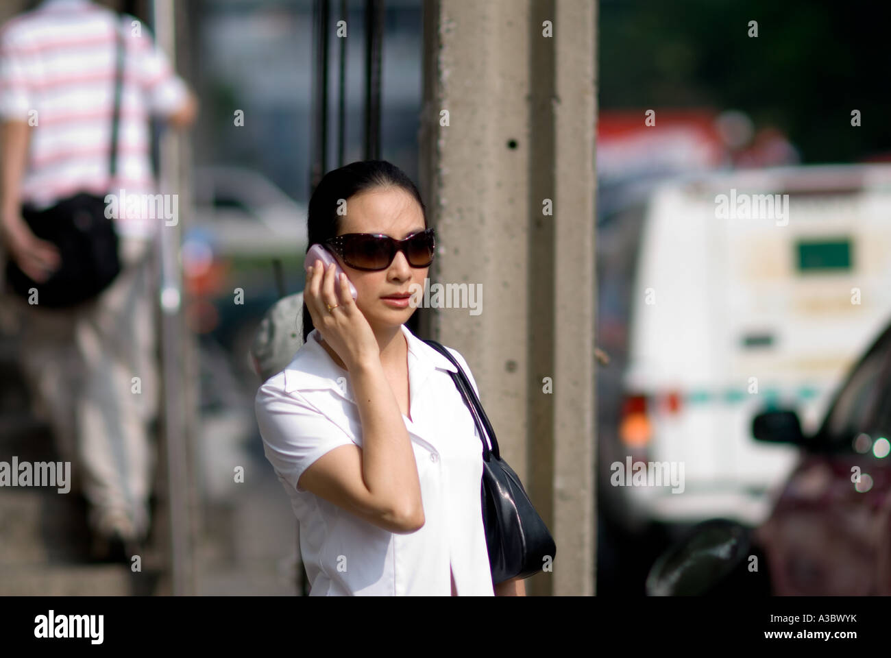 Young Thai businesswoman takes a lunchtime stroll Stock Photo - Alamy