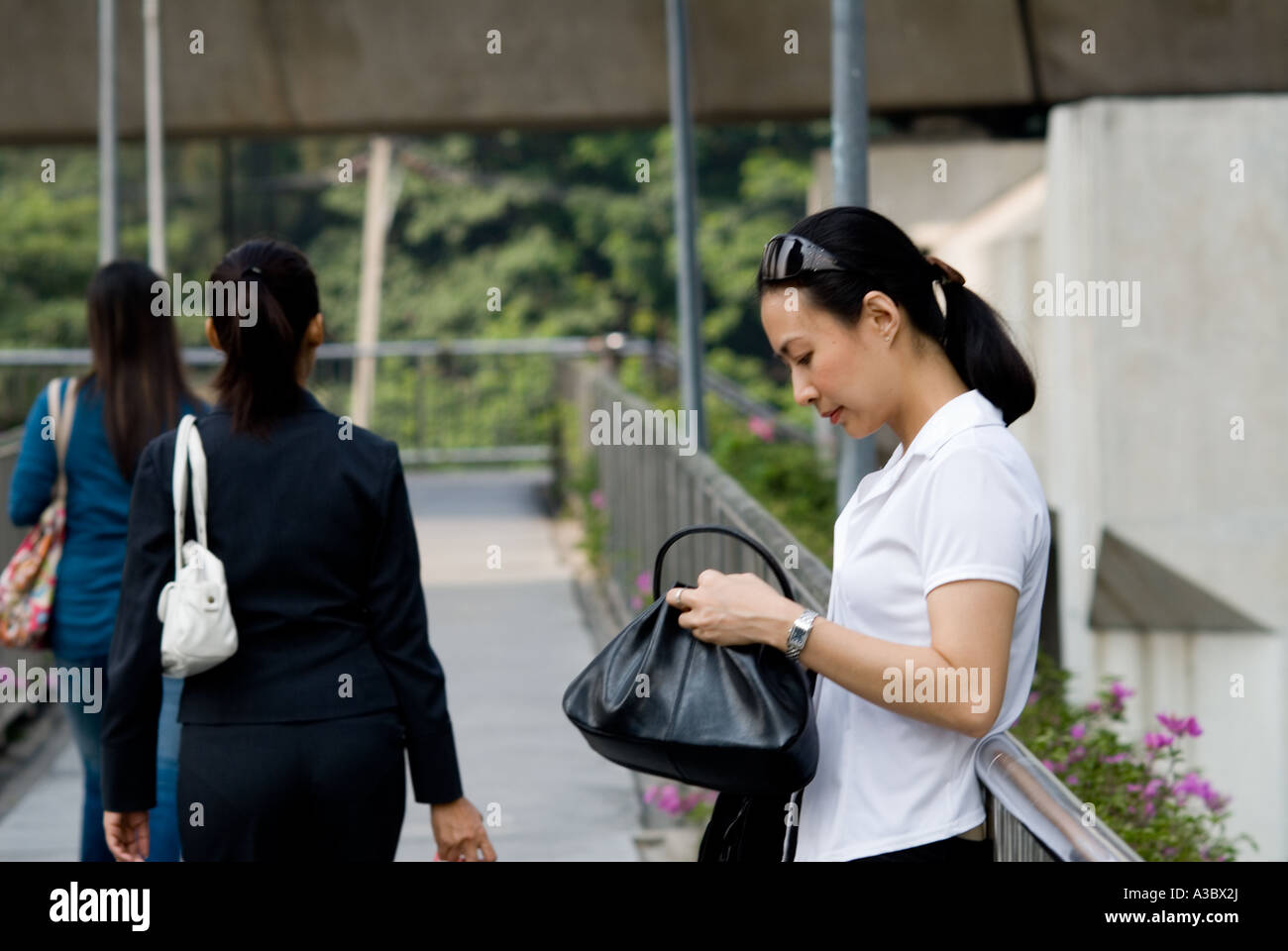 Young Thai businesswoman takes a lunchtime stroll Stock Photo - Alamy