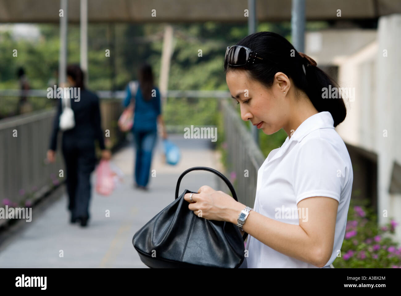 Young Thai businesswoman takes a lunchtime stroll Stock Photo - Alamy
