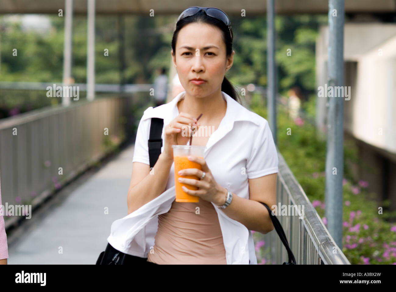 Young Thai businesswoman takes a lunchtime stroll Stock Photo - Alamy