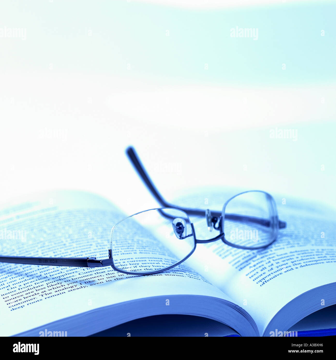 an open book with glasses Stock Photo - Alamy