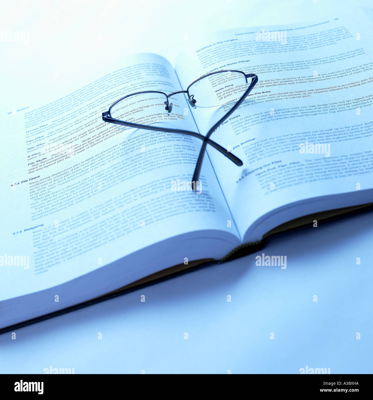 an open book with lots of words and glasses Stock Photo - Alamy