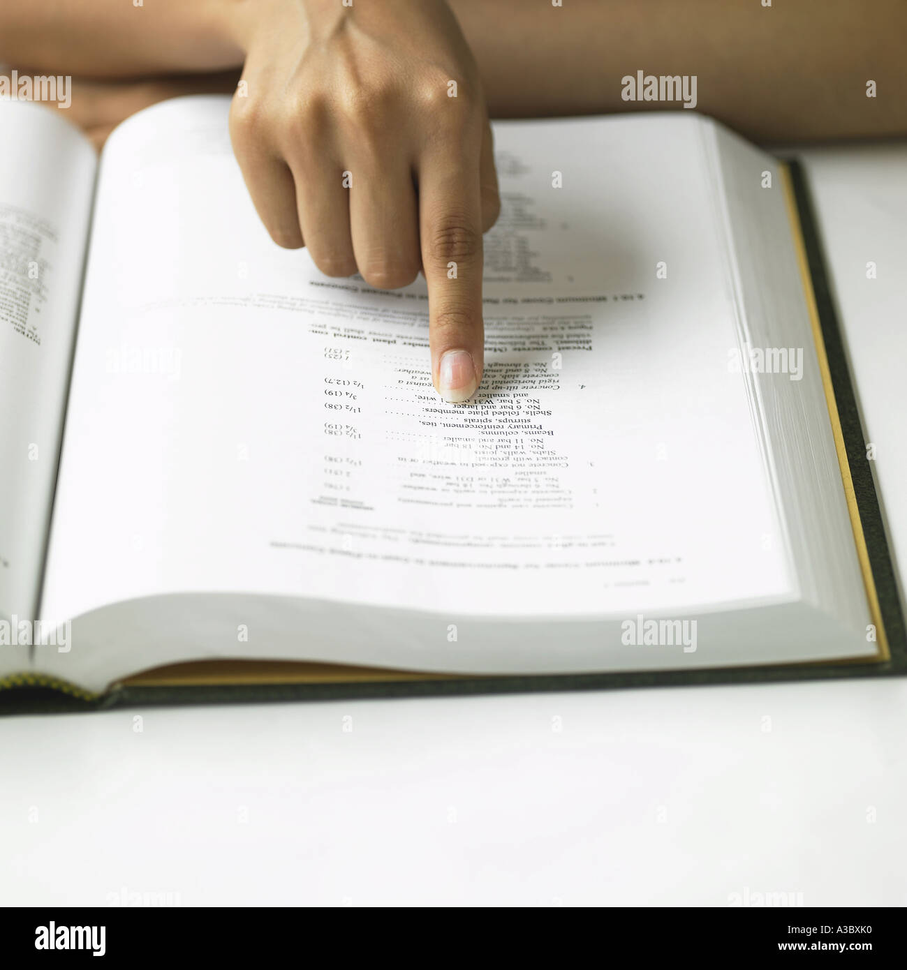 someone is pointing at a word in an open book Stock Photo - Alamy