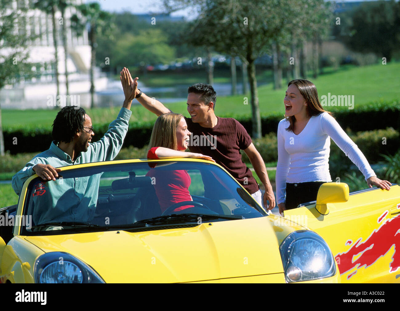 Teenagers having fun with cool car Stock Photo - Alamy
